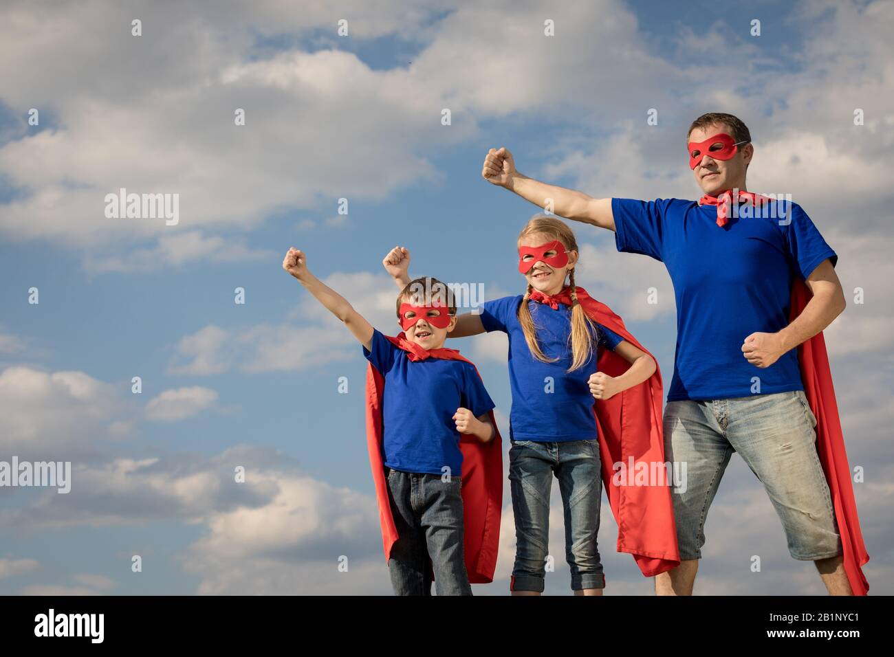 Father and children playing superhero at the day time. People having ...