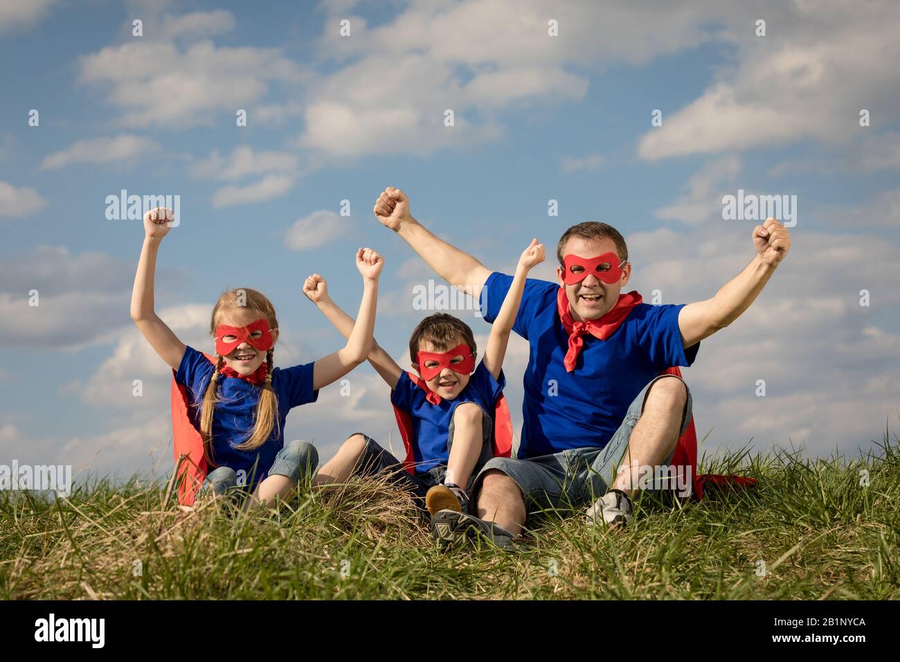 Father and children playing superhero at the day time. People having ...