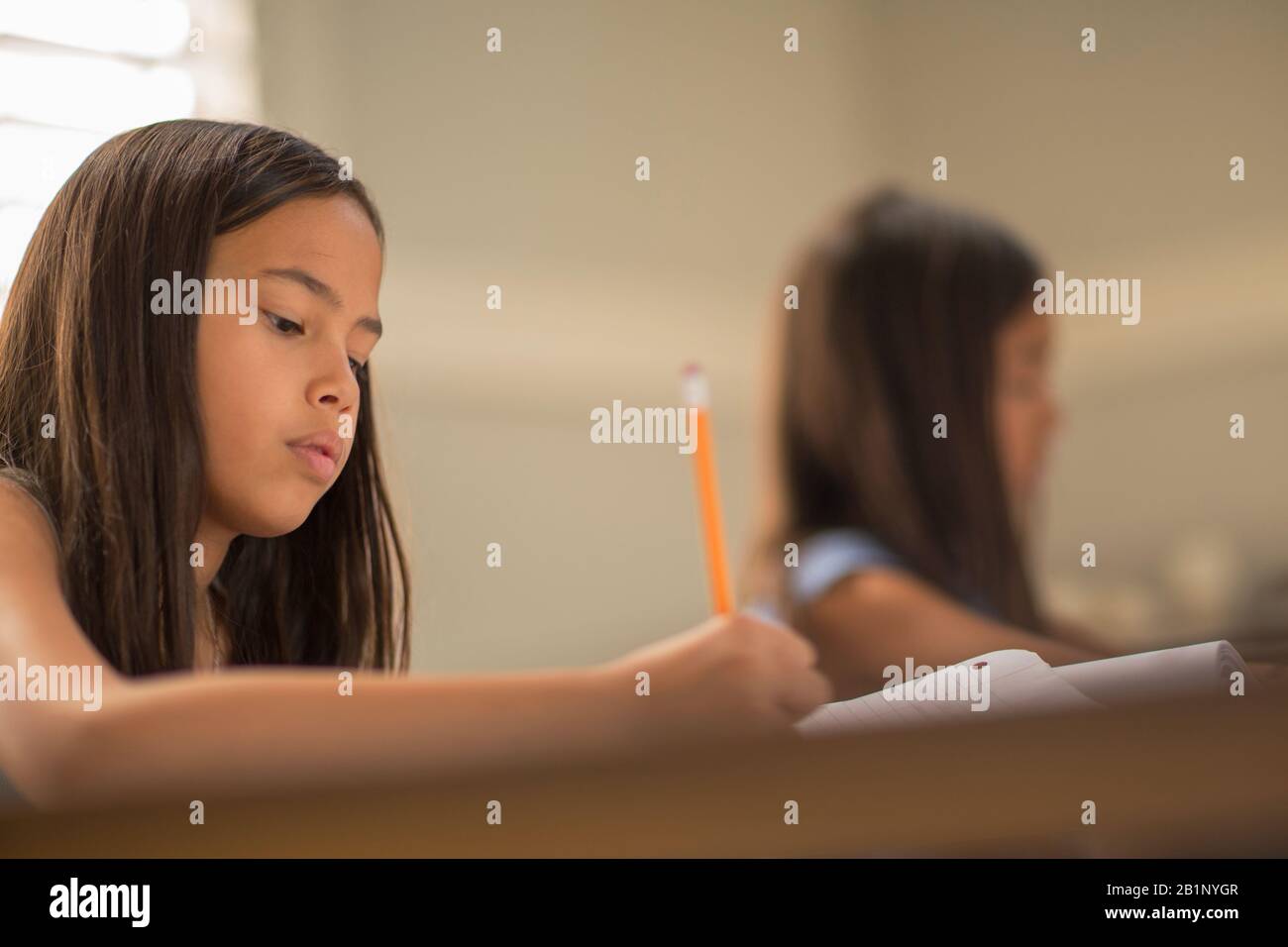 Young Girls Working On Their School Work Stock Photo - Alamy