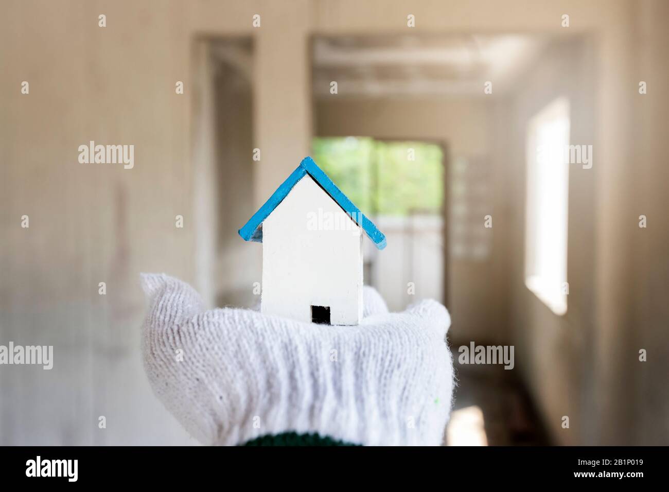 House model on a worker (architect, foreman, engineer) hand ...