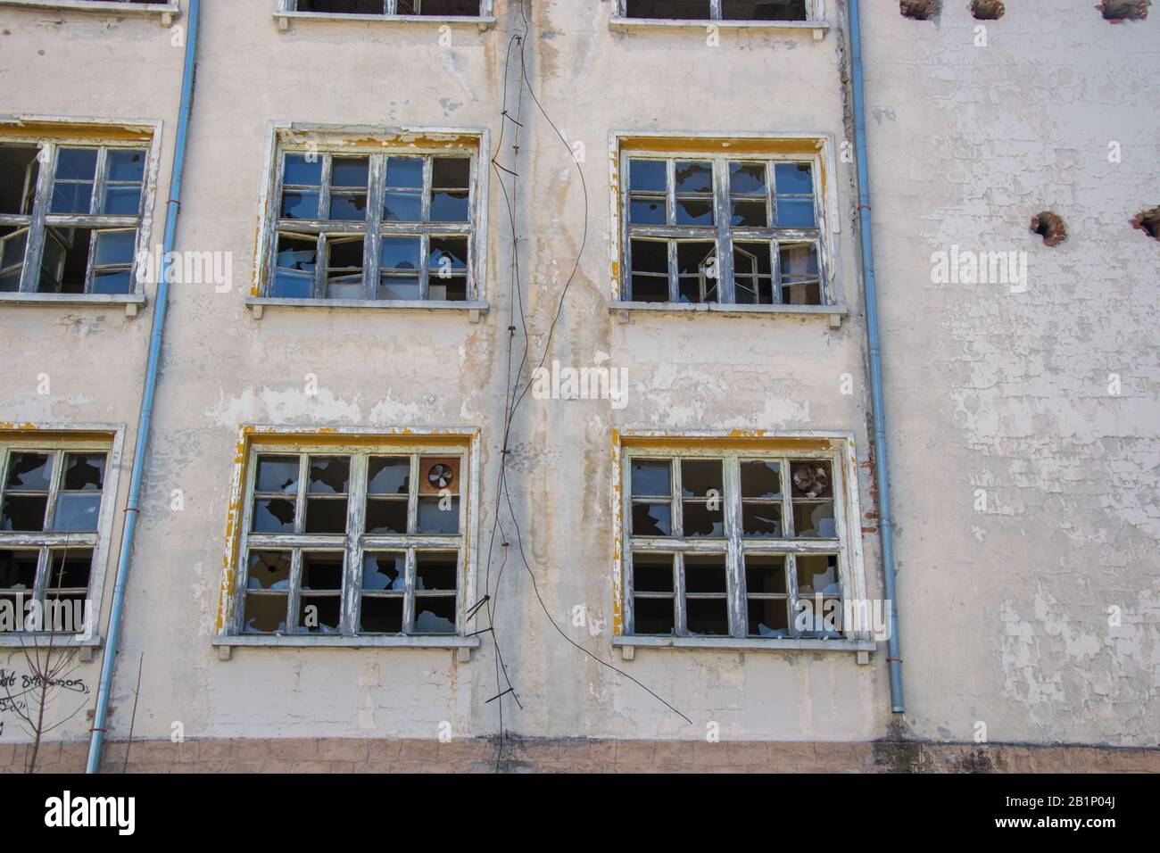 Broken damaged glass windows on a building, outdoors. Damaged window ...