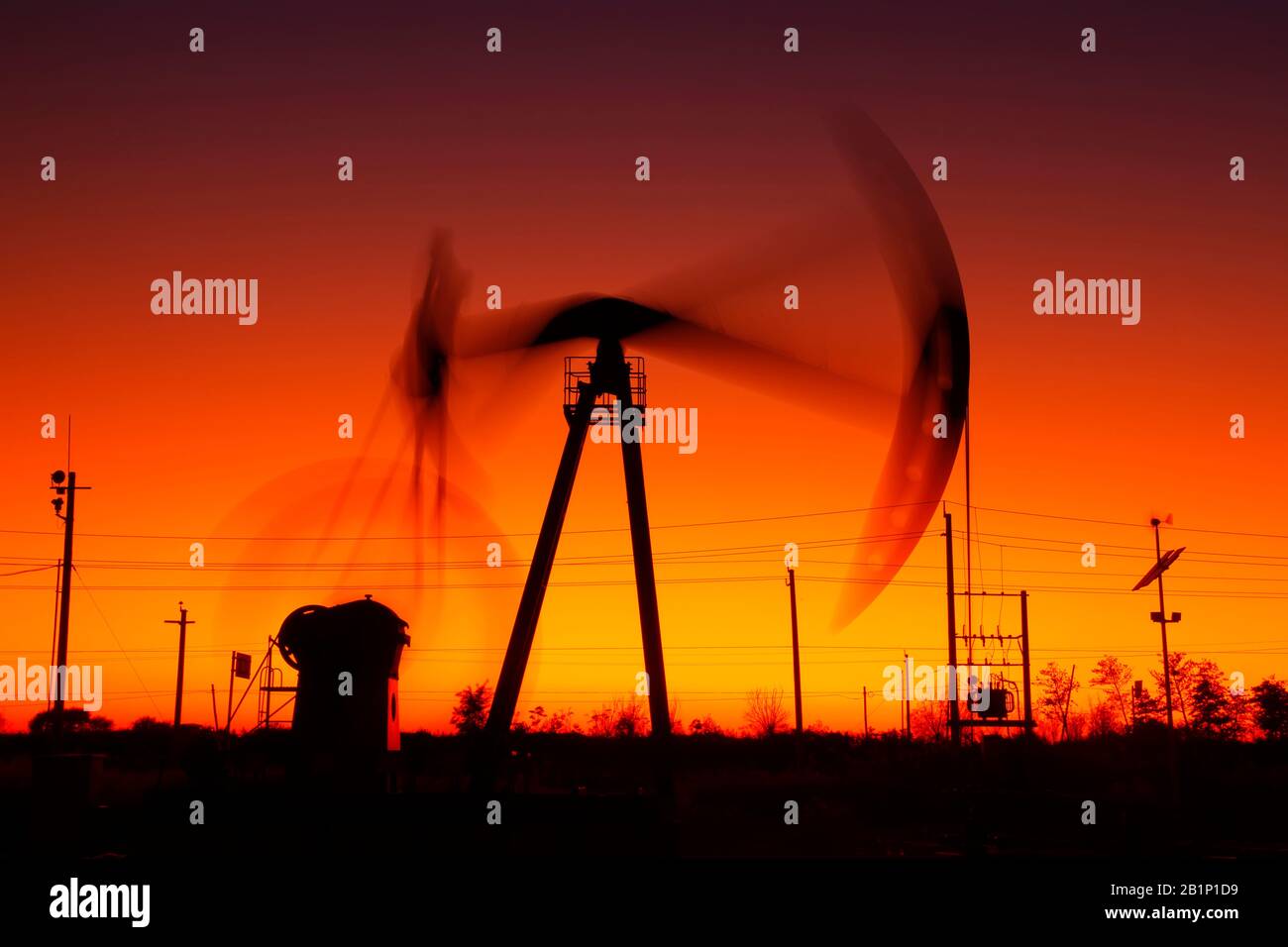 Oil field scene, the evening of beam pumping unit in silhouette Stock ...