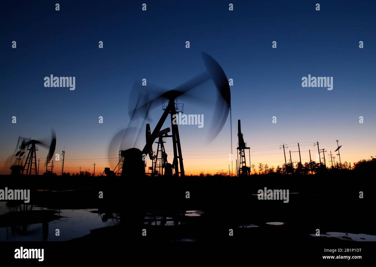 Oil field scene, the evening of beam pumping unit in silhouette Stock ...