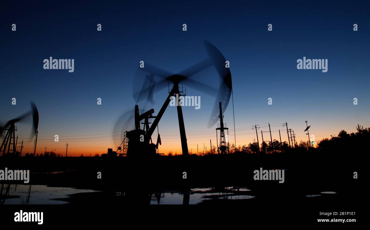 Oil field scene, the evening of beam pumping unit in silhouette Stock ...