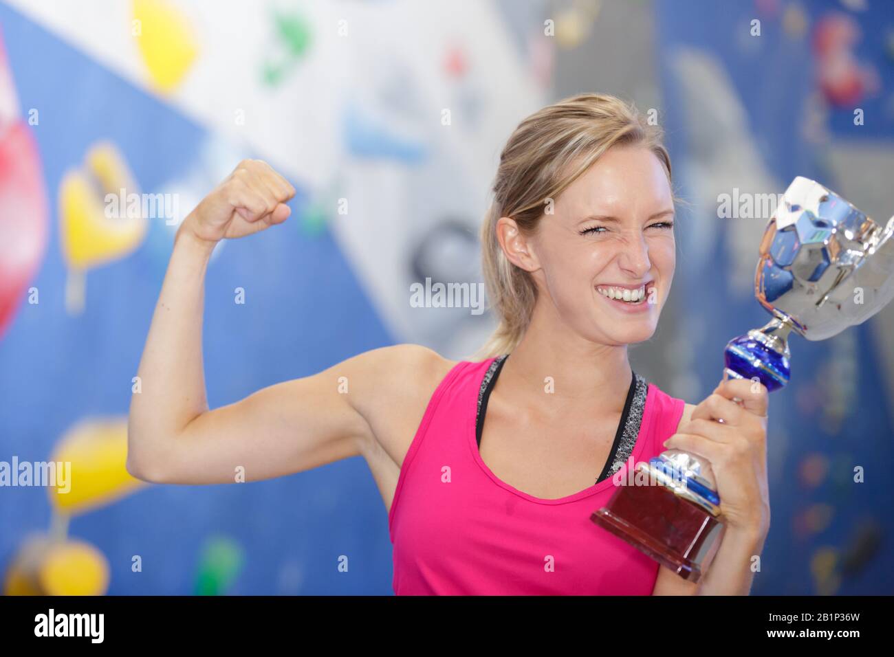 portrait of female raising gold trophy to celebrate Stock Photo - Alamy