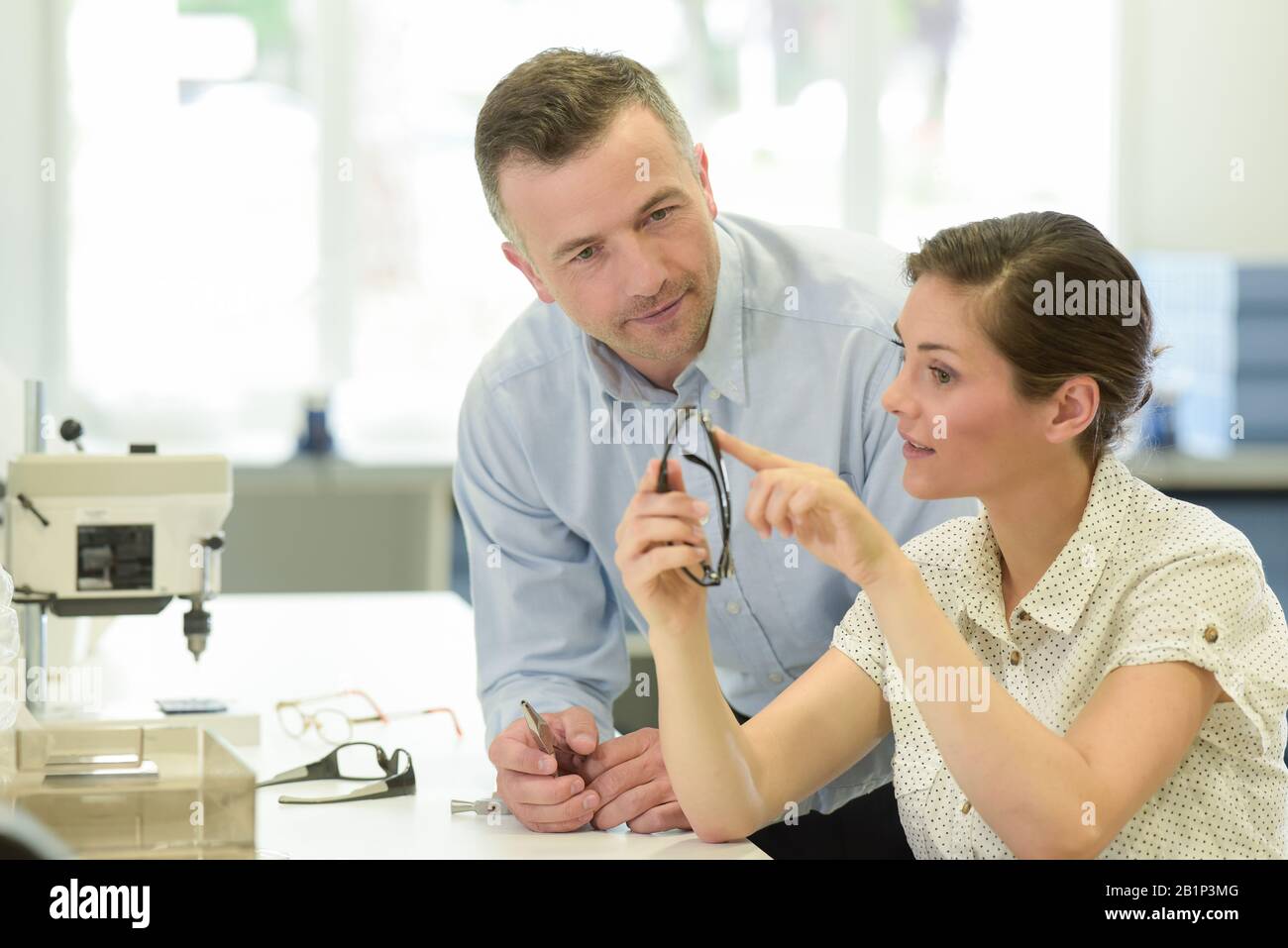 female optician measuring and preparing glasses Stock Photo - Alamy
