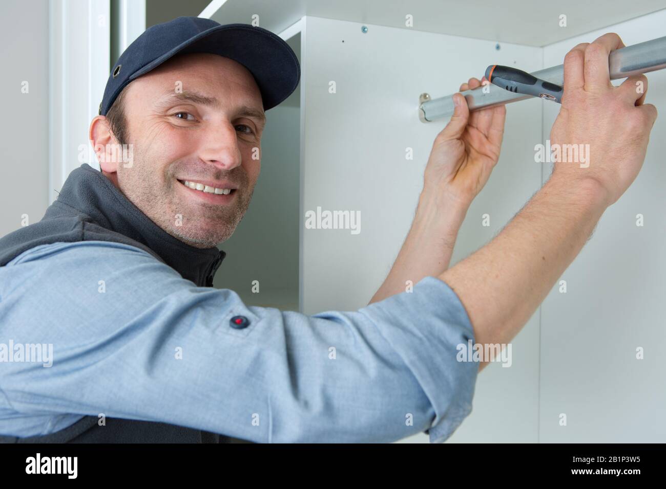 fixing a shelf Stock Photo - Alamy