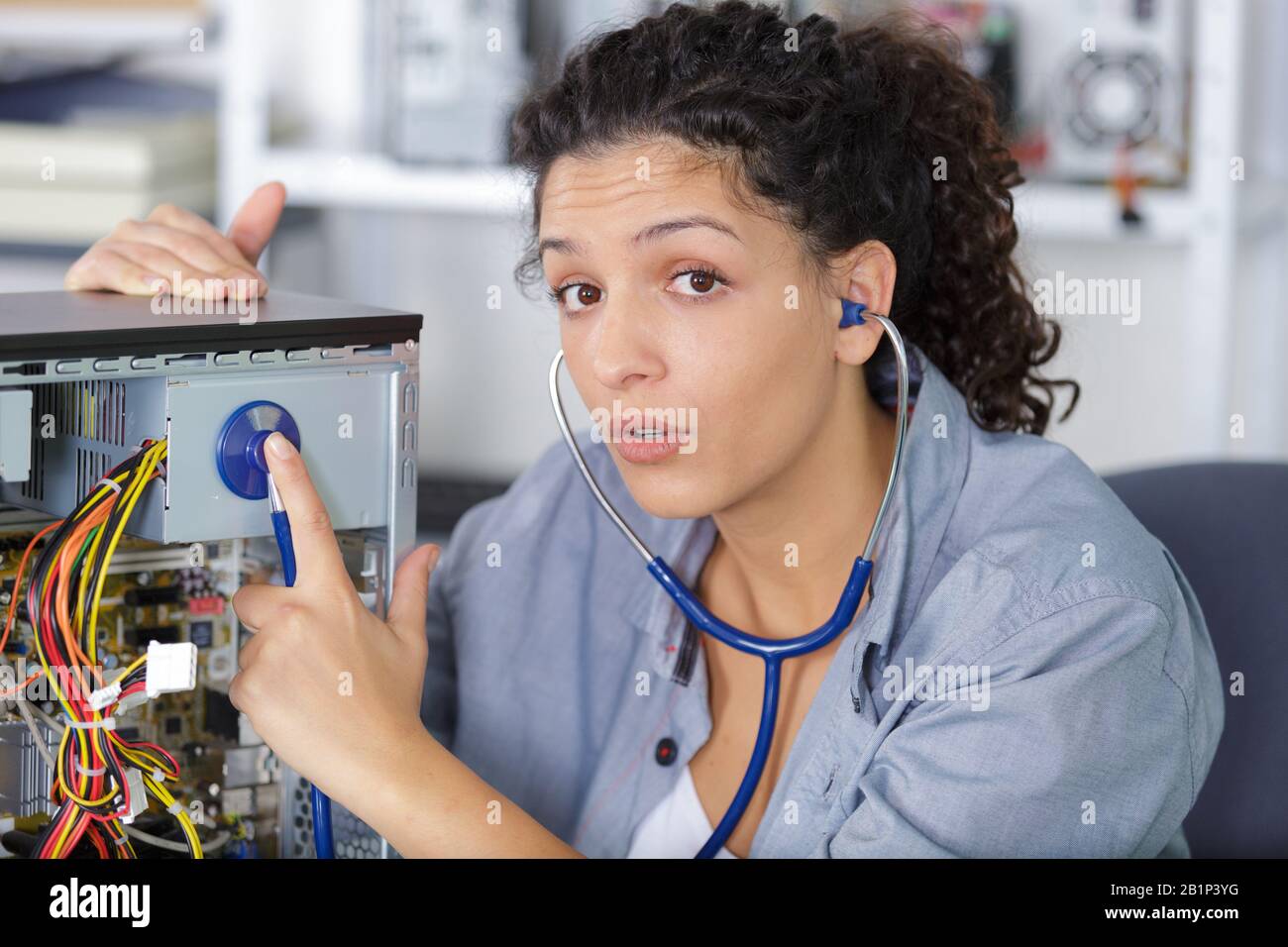 hardware professional examining cpu with stethoscope Stock Photo - Alamy
