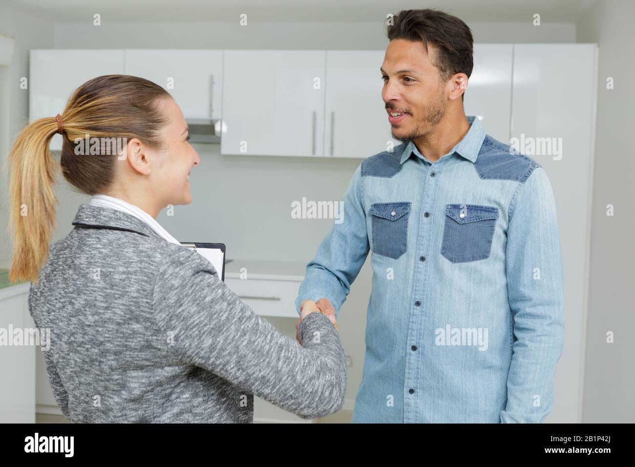broker and client shaking hands Stock Photo - Alamy