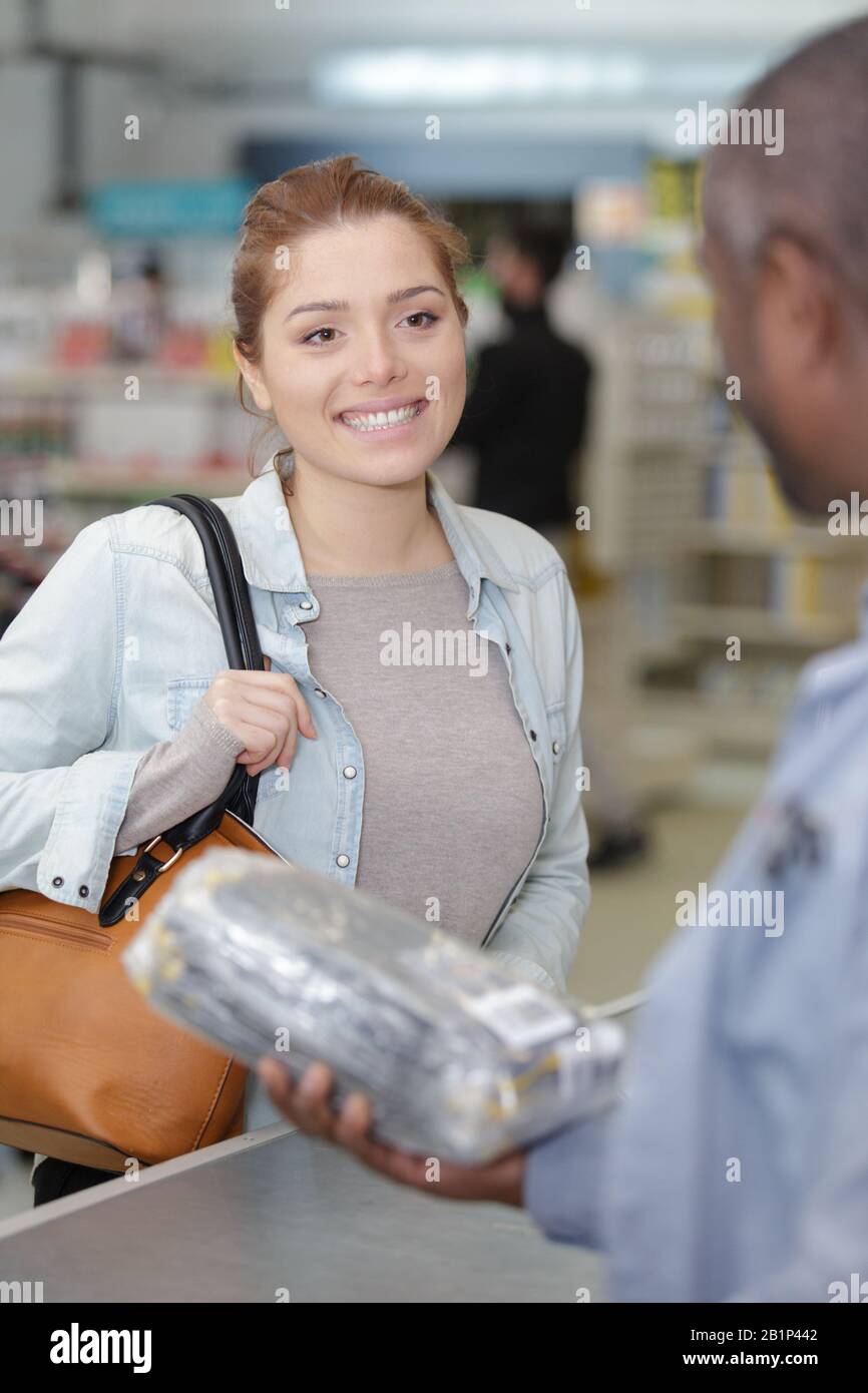 Brown male shop assistant hi-res stock photography and images - Alamy