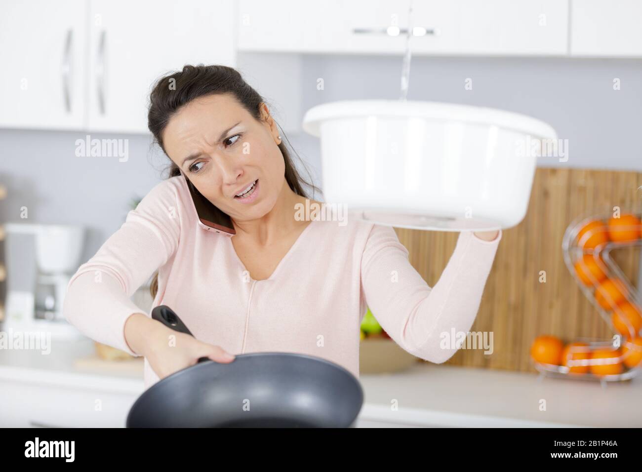 angry woman calling to plumber Stock Photo - Alamy