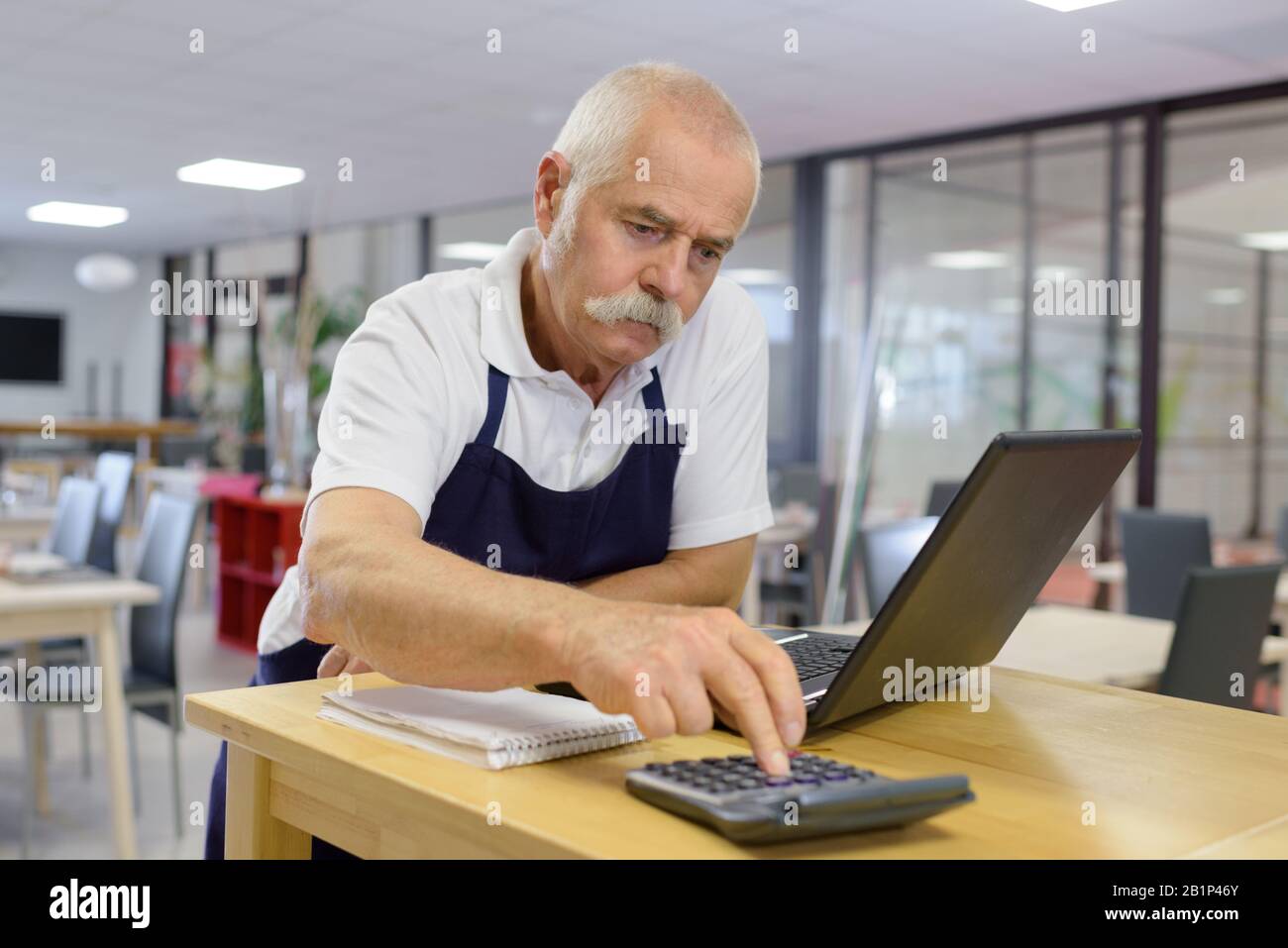 senior bar owner during business calculation Stock Photo - Alamy