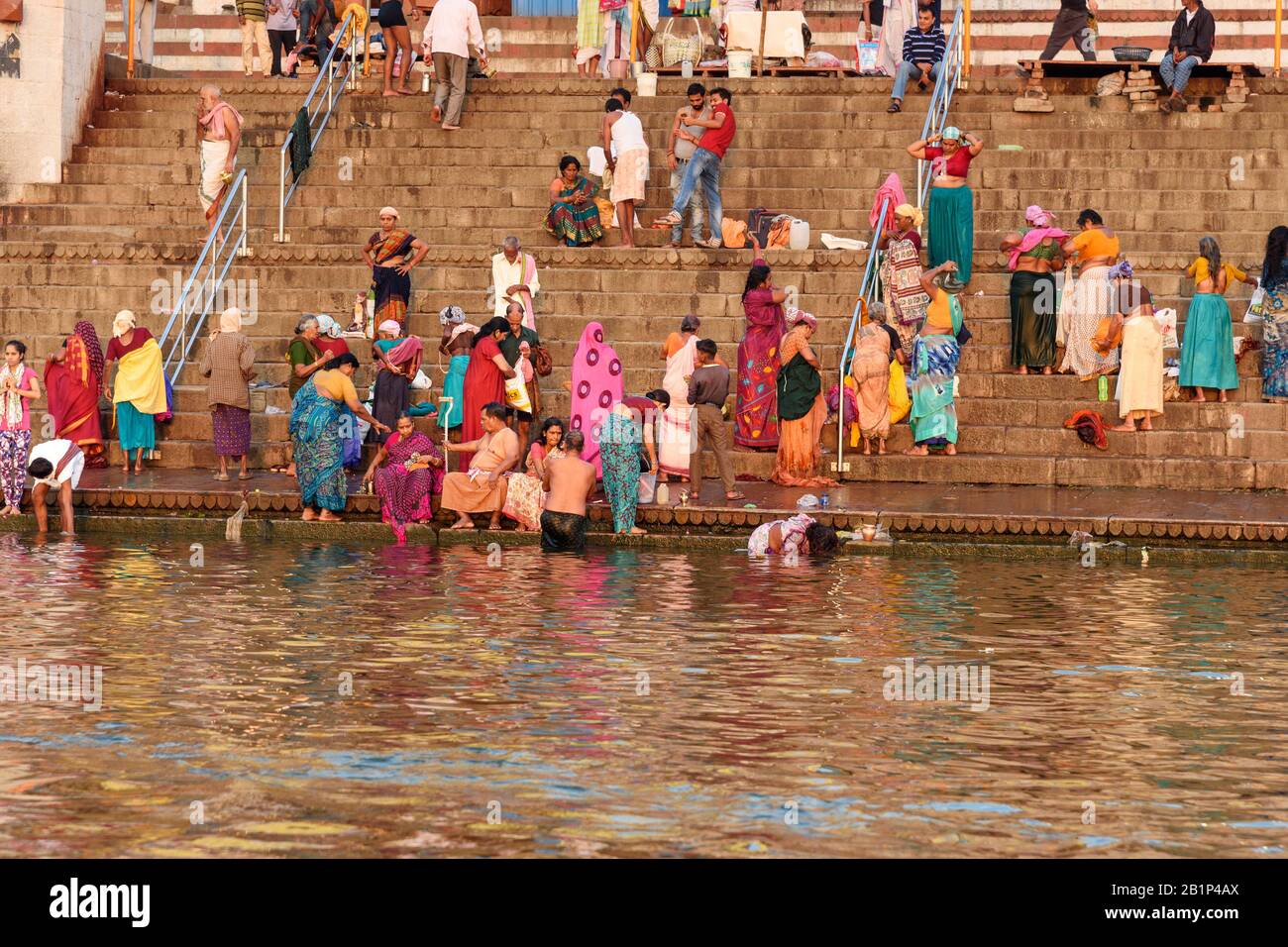 People bathing in water holy Ganga river at Kedar Ghat in morning ...