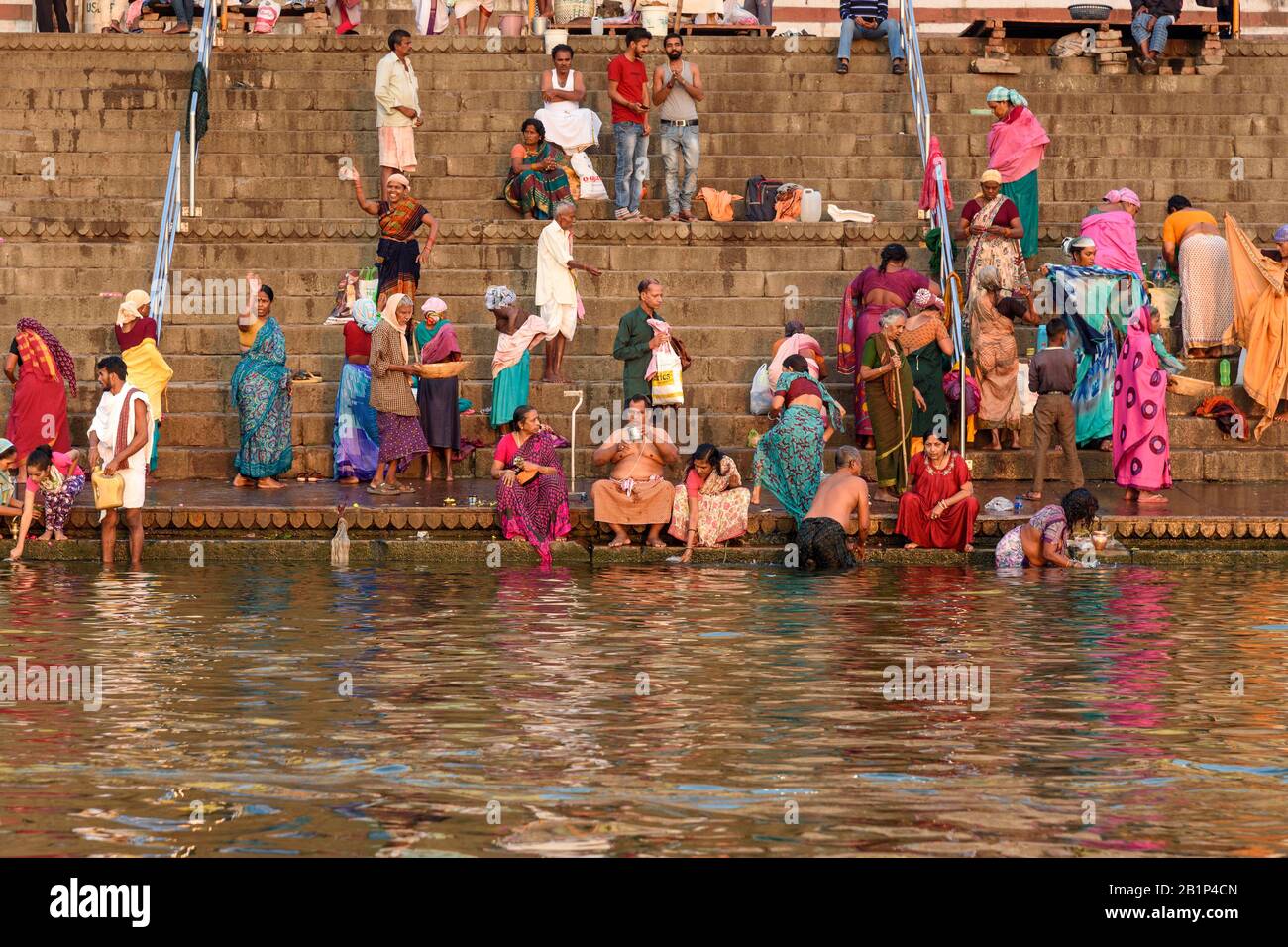 People bathing in water holy Ganga river at Kedar Ghat in morning ...