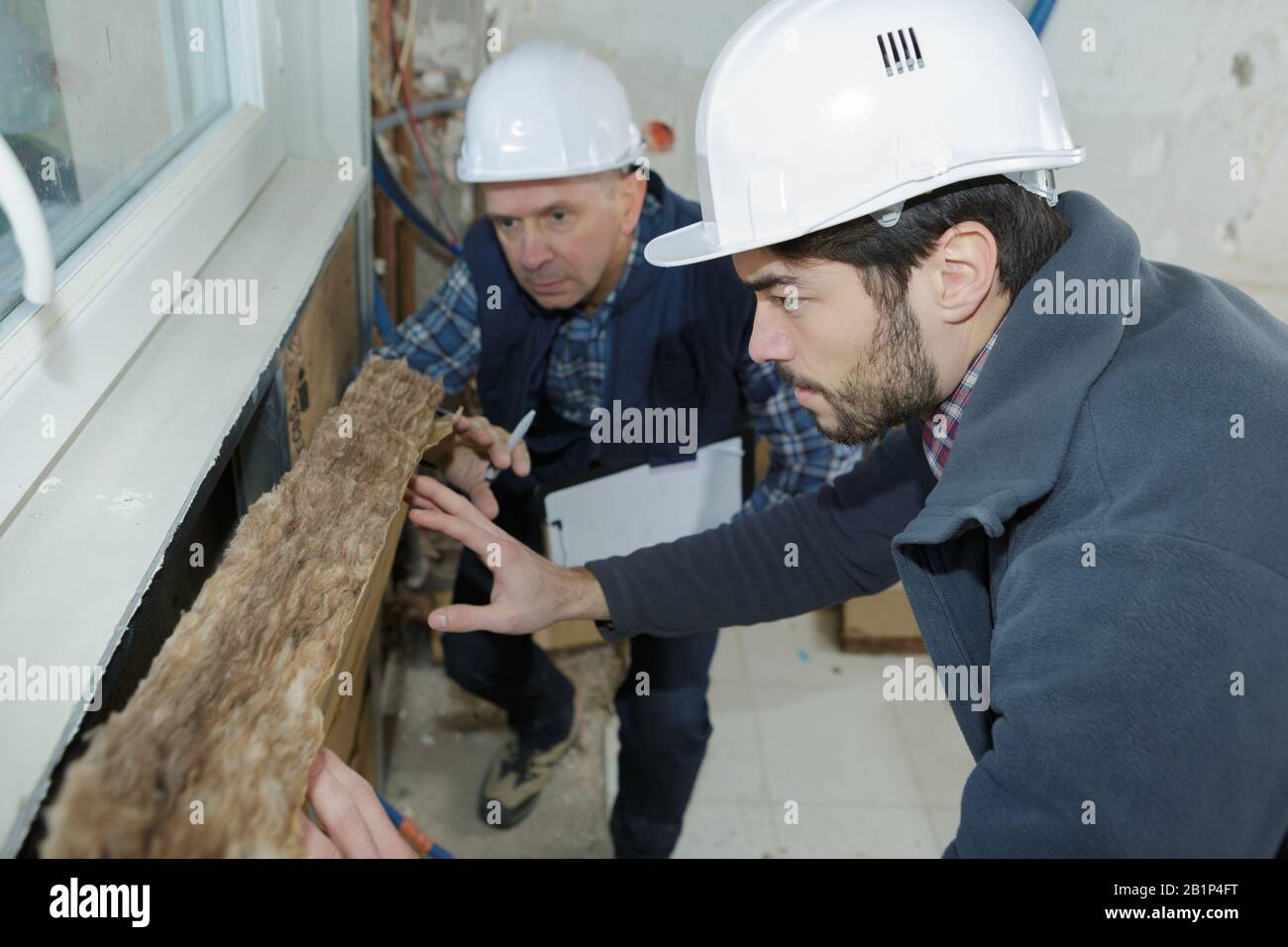 two carpenters working at location Stock Photo - Alamy