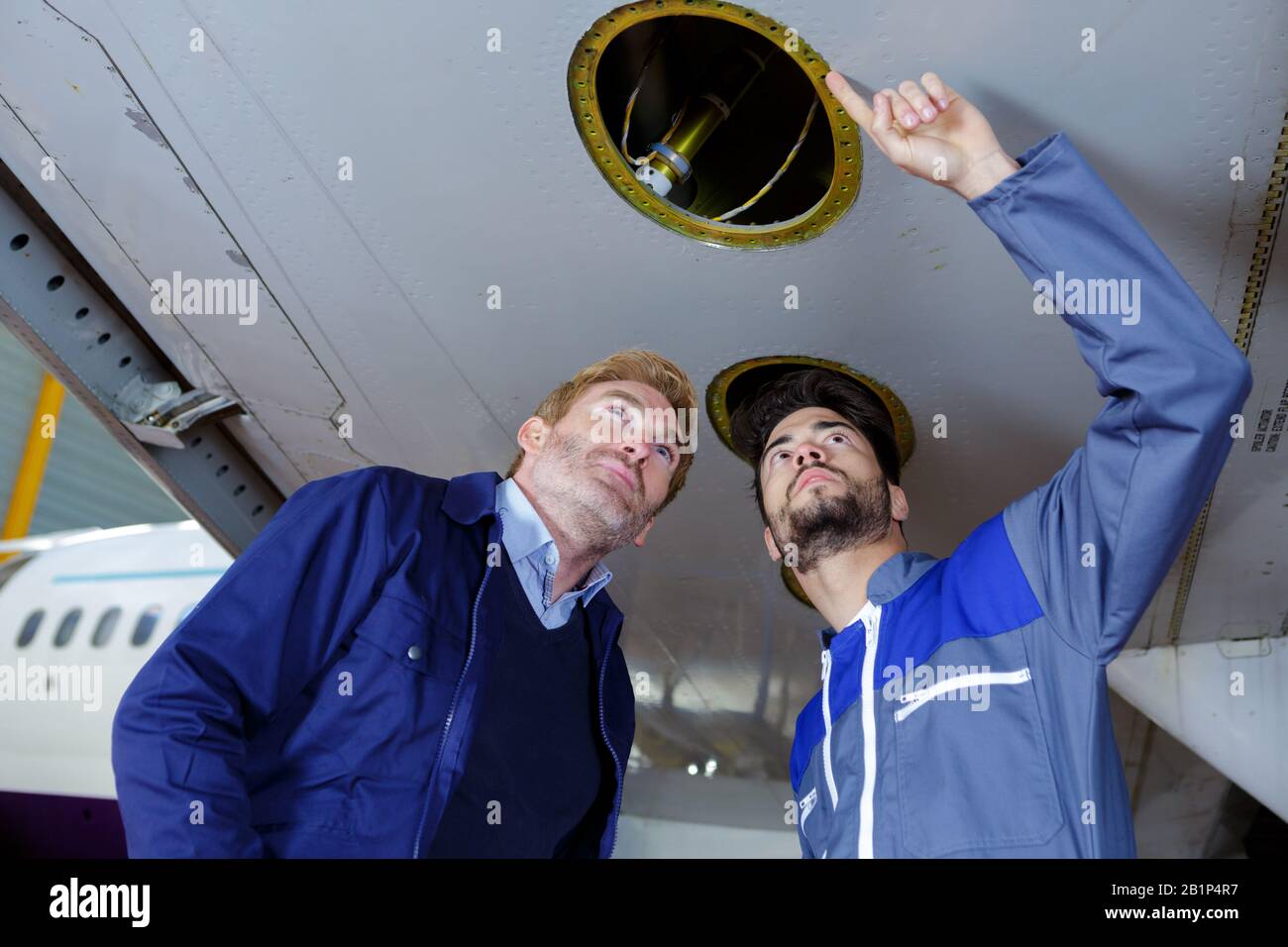 male aero engineer working in helicopter cockpit Stock Photo - Alamy