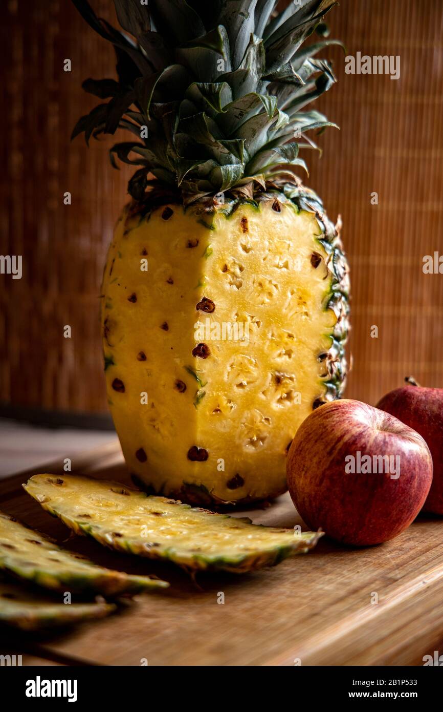 Pineapple and red apples Stock Photo - Alamy