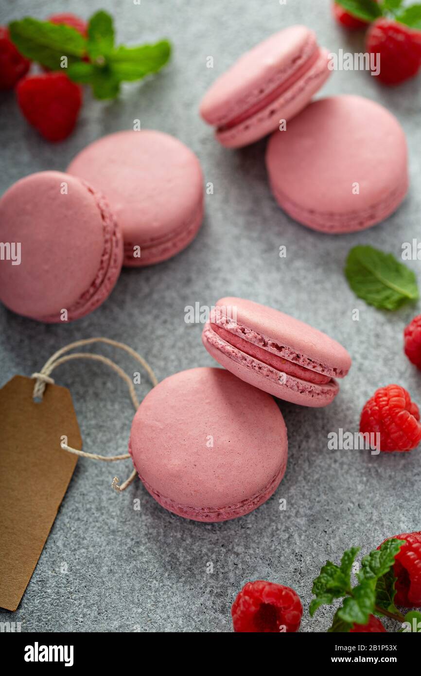 Raspberry macarons on gray table Stock Photo - Alamy