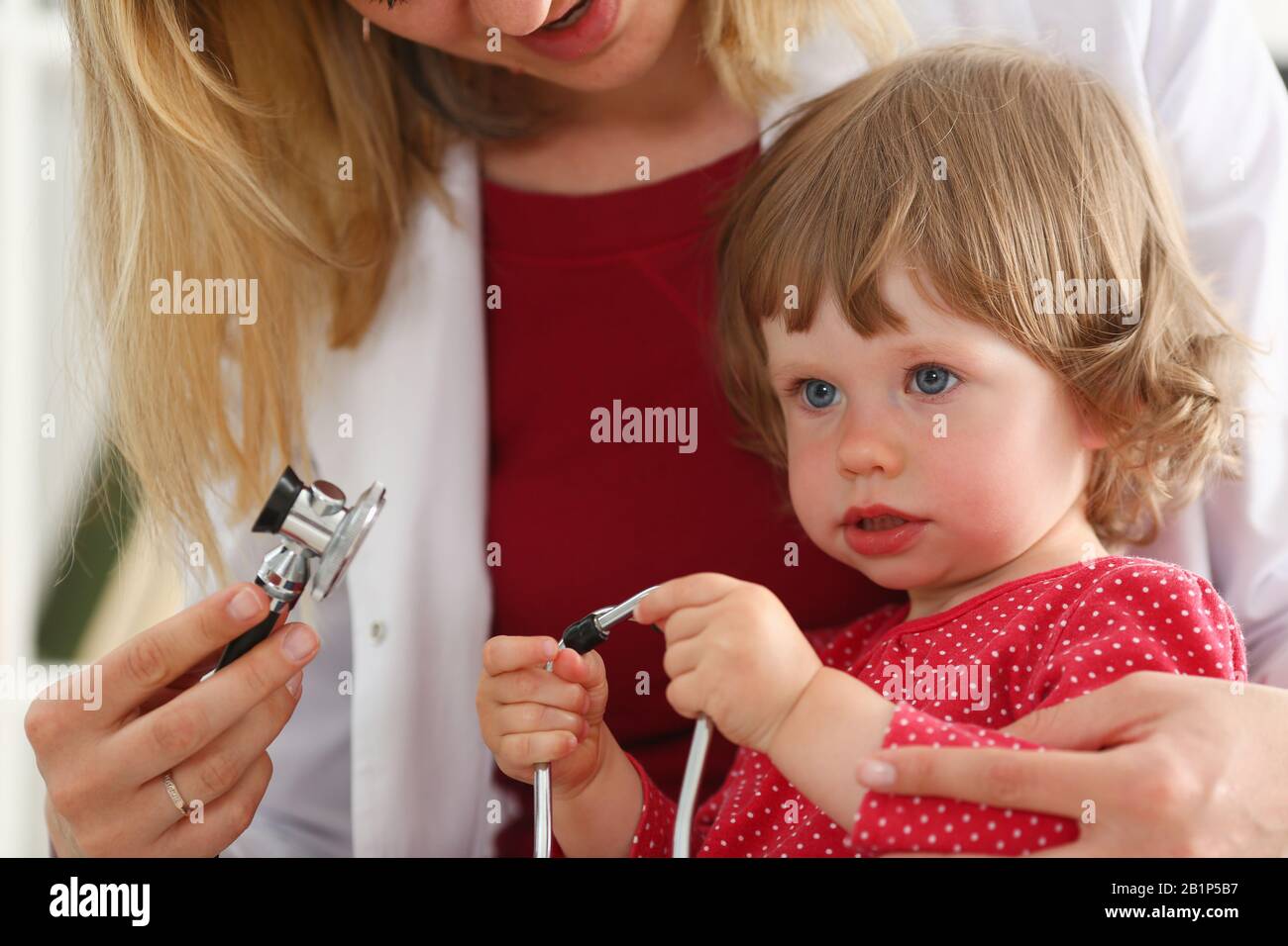 Little child with stethoscope at doctor reception Stock Photo - Alamy