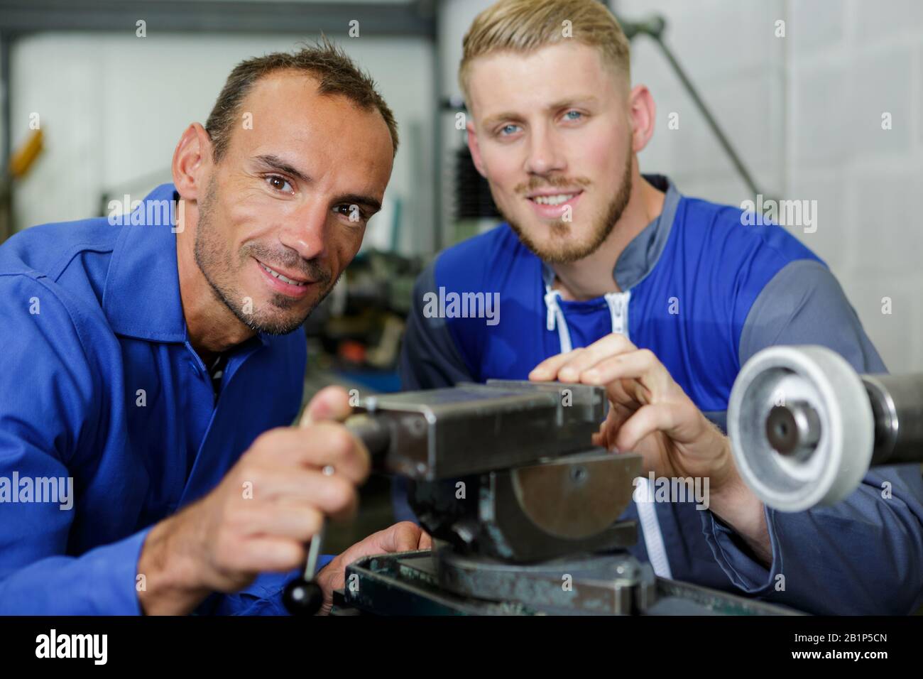 a machinist and apprentice posing Stock Photo - Alamy