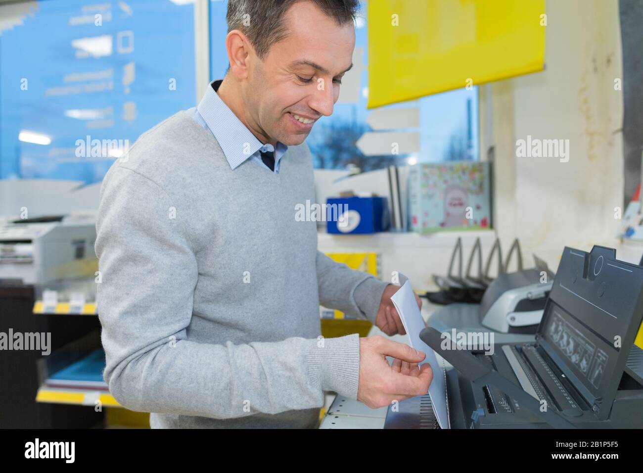 worker inserting paper in the fax machine Stock Photo - Alamy
