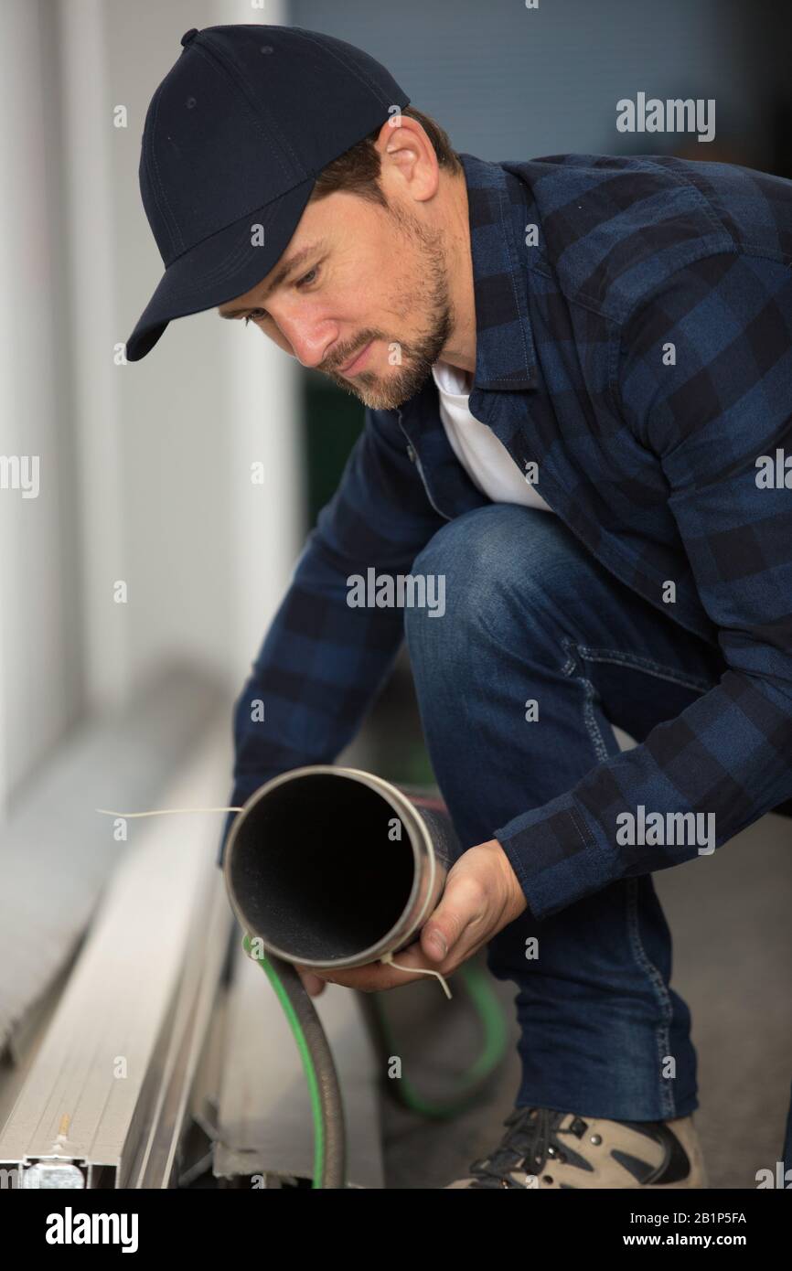 happy man during installation of pipes indoors Stock Photo - Alamy