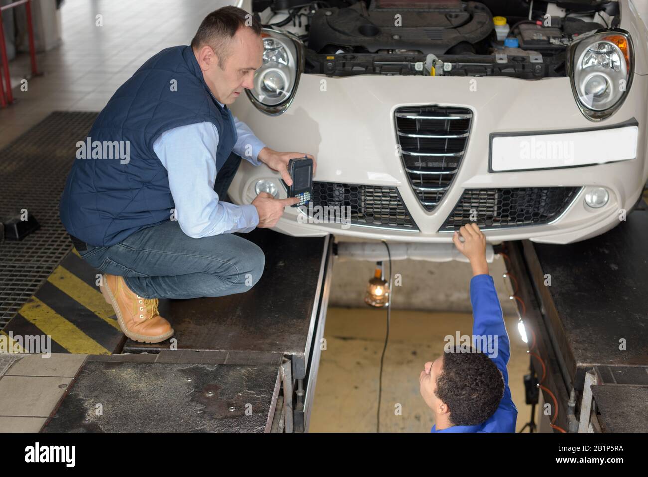 Car mechanic in inspection pit hi-res stock photography and images - Alamy
