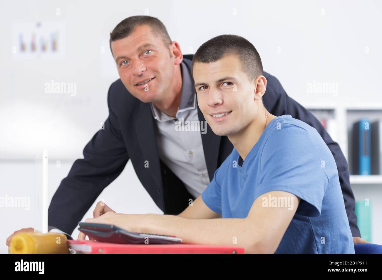handsome teacher and student in classroom Stock Photo - Alamy