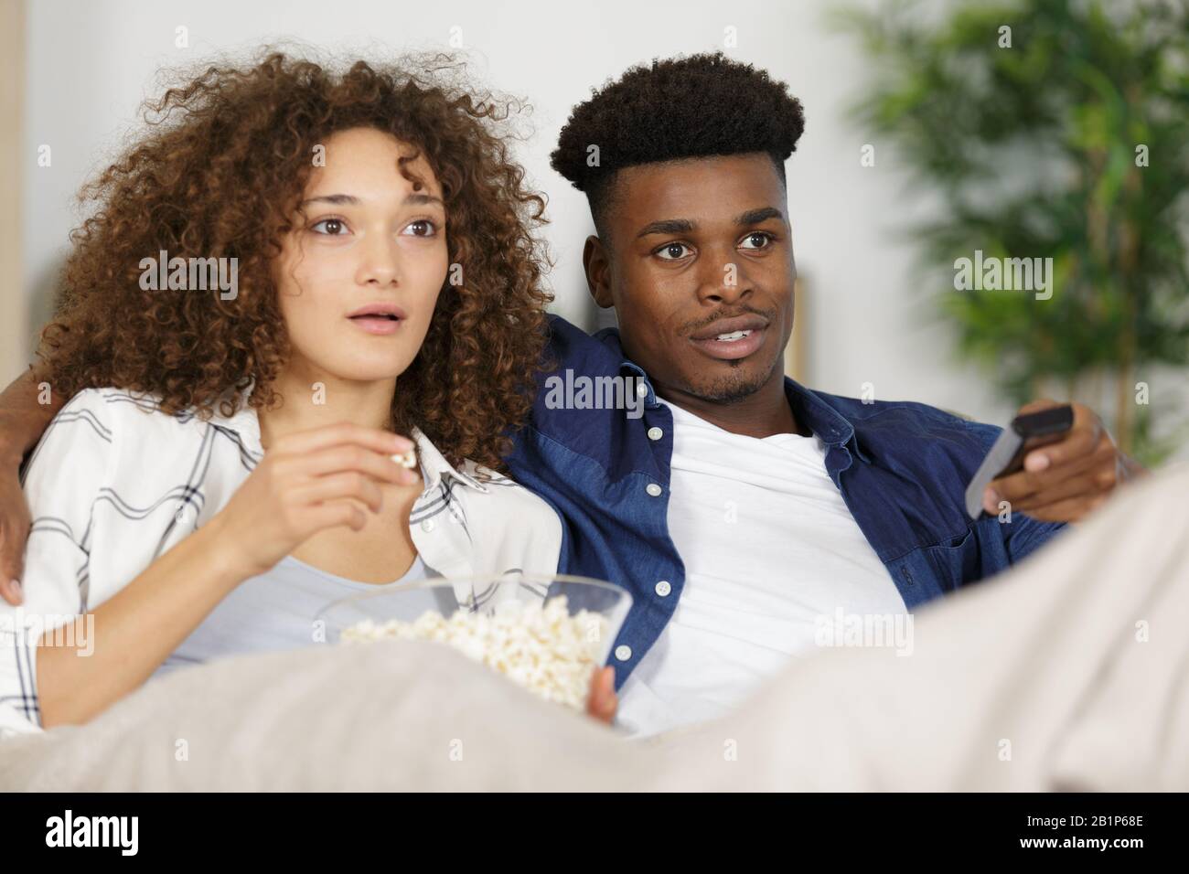 multi-racial couple engrossed in movie Stock Photo - Alamy