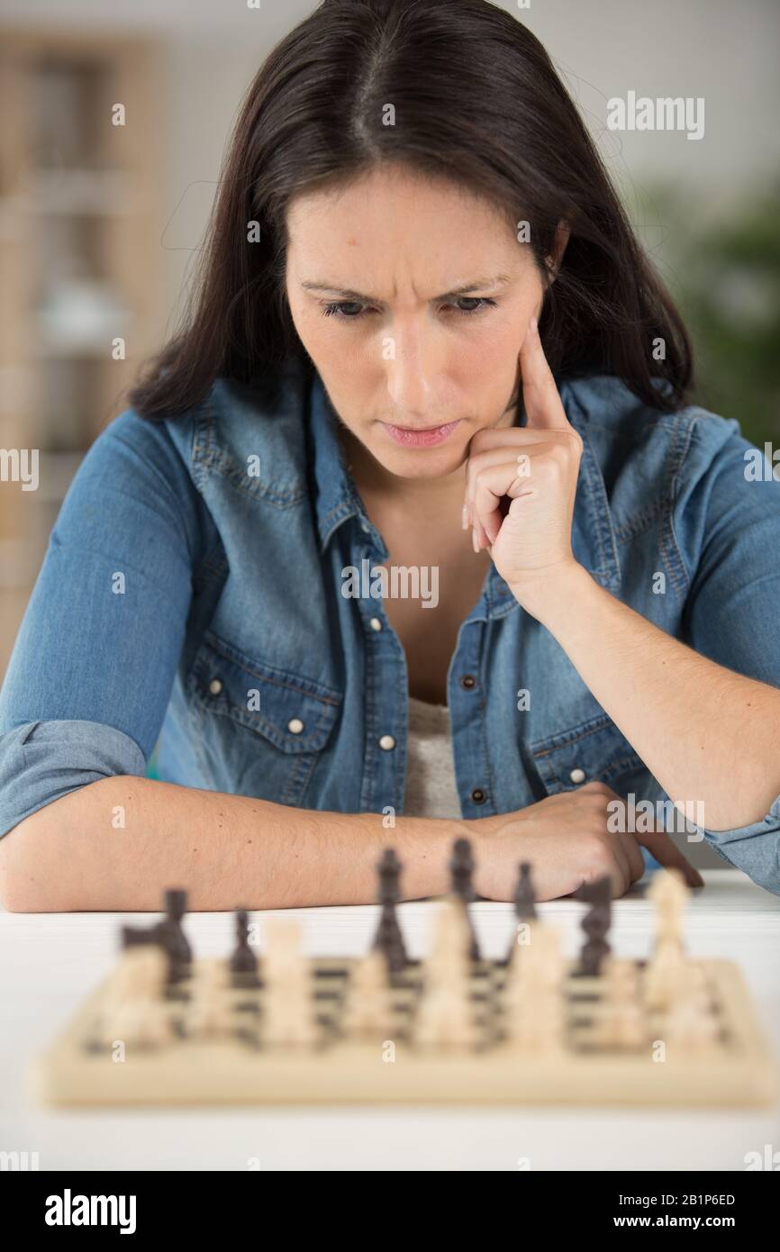 woman at home playing chess alone Stock Photo - Alamy