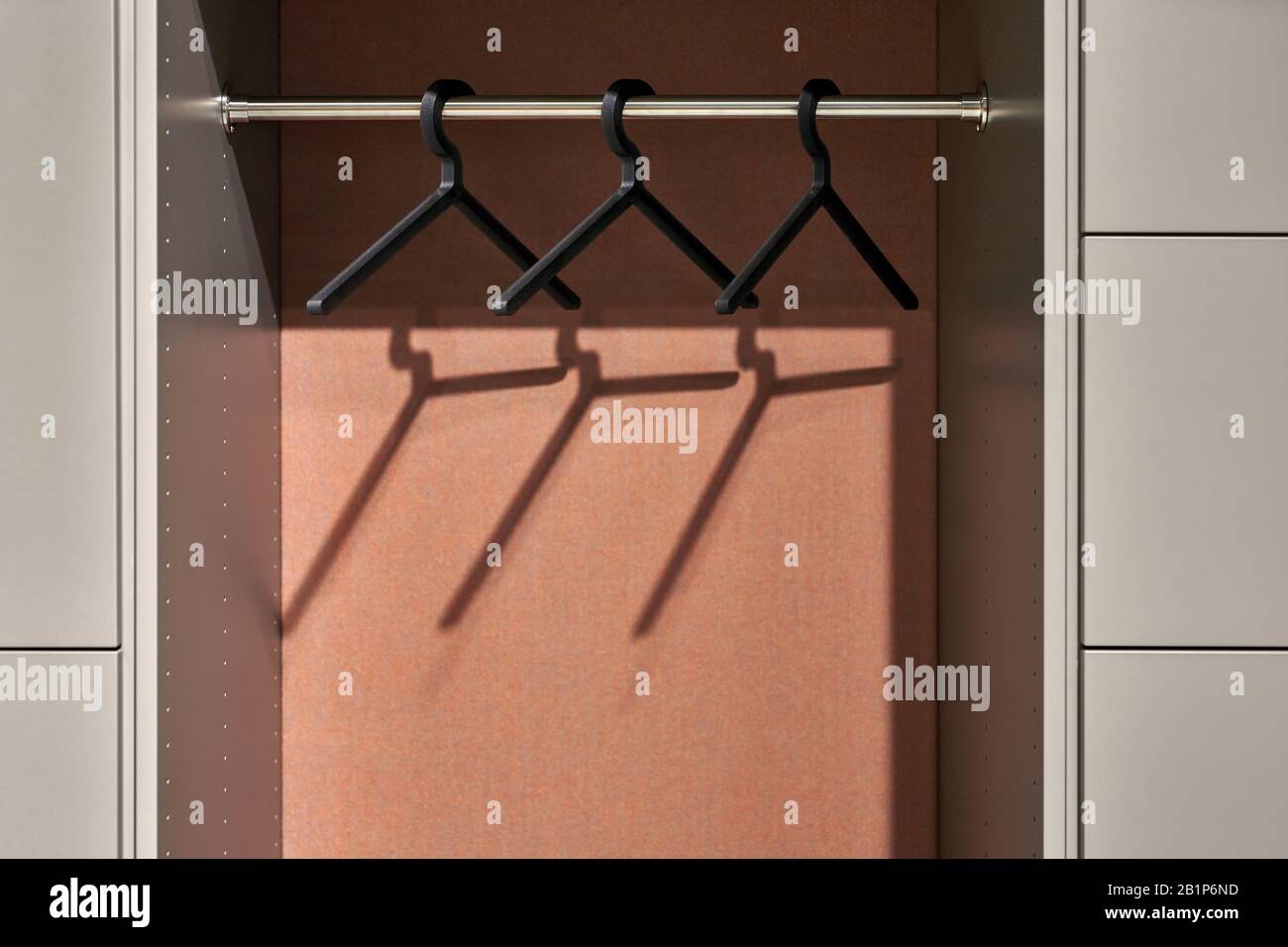 Closeup view at hangers on rack in wardrobe Stock Photo - Alamy