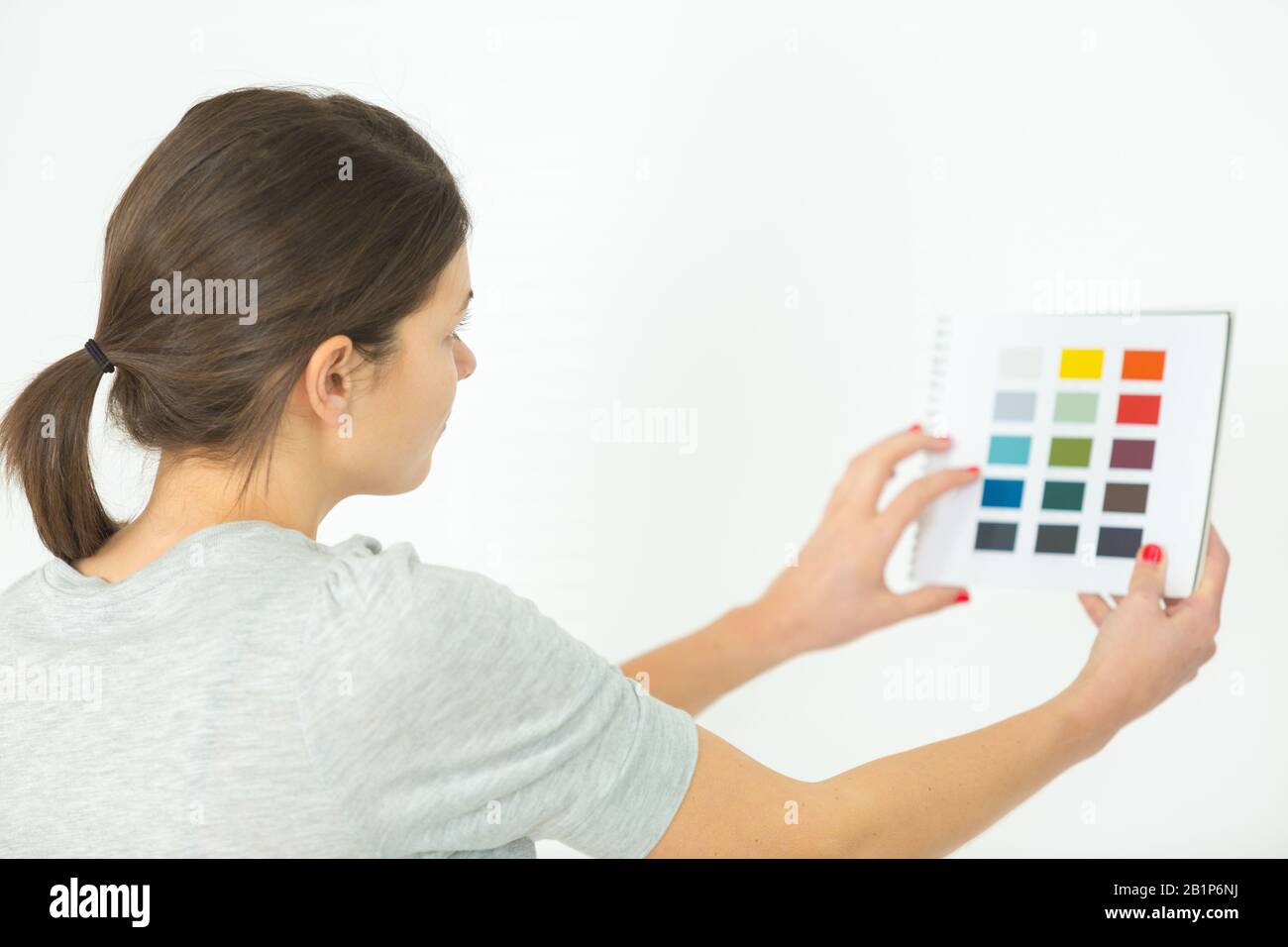 woman designer choosing wall color from color palette Stock Photo - Alamy
