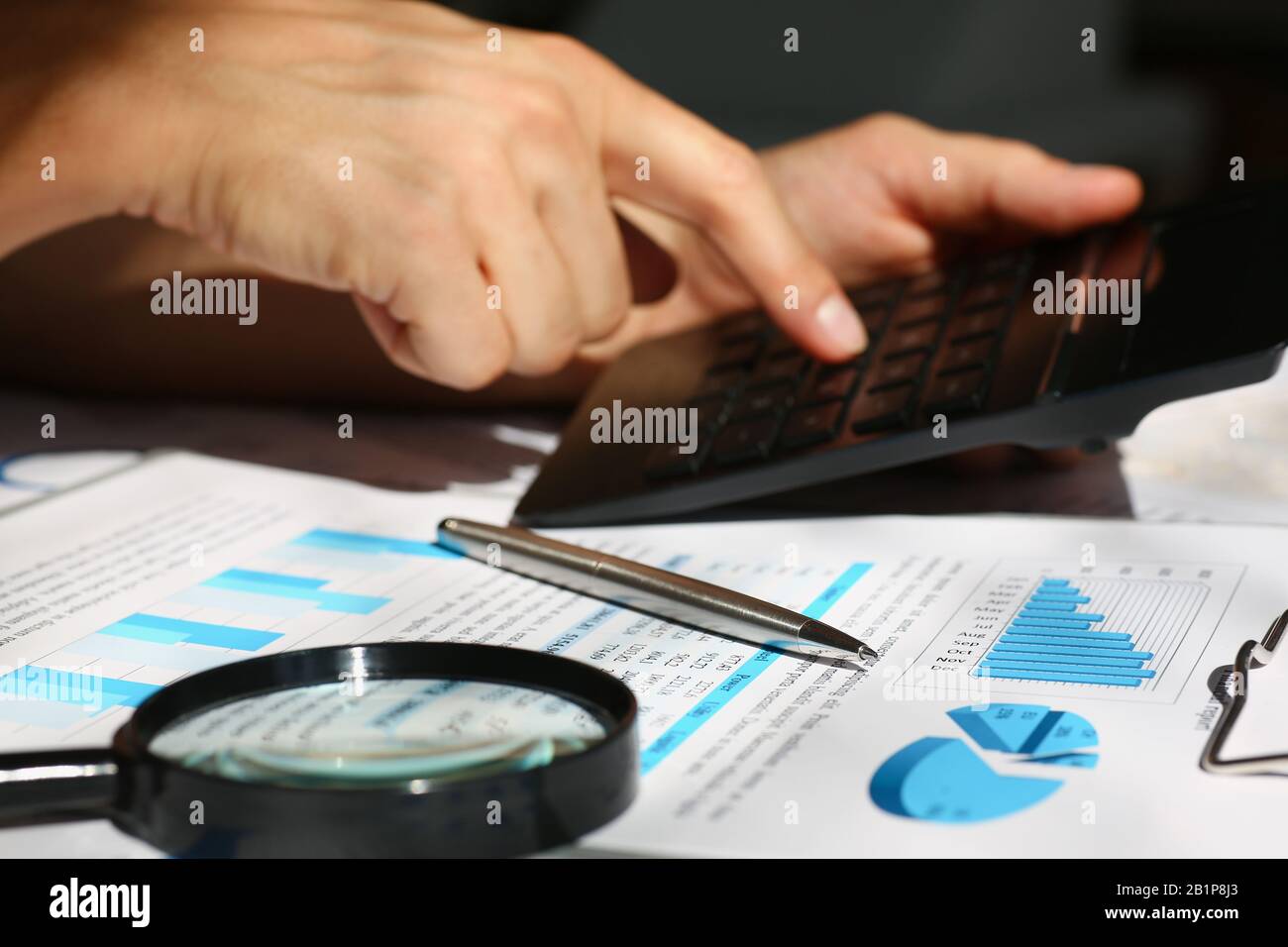 Black calculator and financial statistics on infographics Stock Photo ...