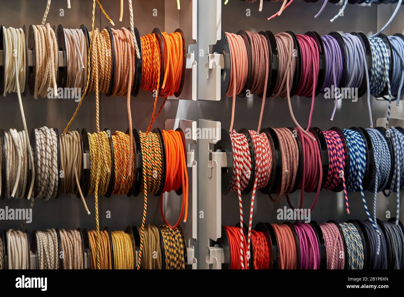 Stand with coils of multicolored textile braided cables Stock Photo - Alamy