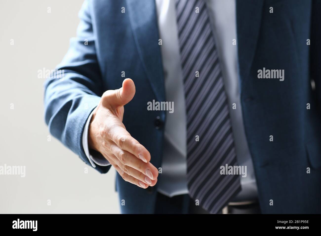 Businessman offer hand to shake as hello in office Stock Photo - Alamy