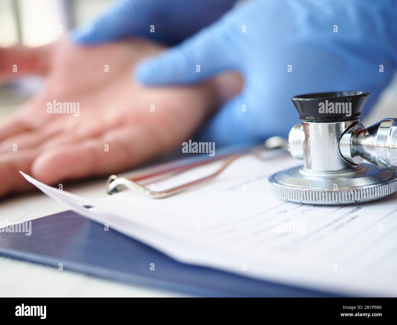 The doctor examines the healing wound of the patient on the hand palm ...