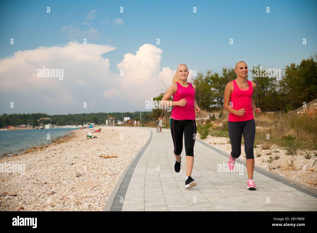 Two women running on beach hi-res stock photography and images - Alamy