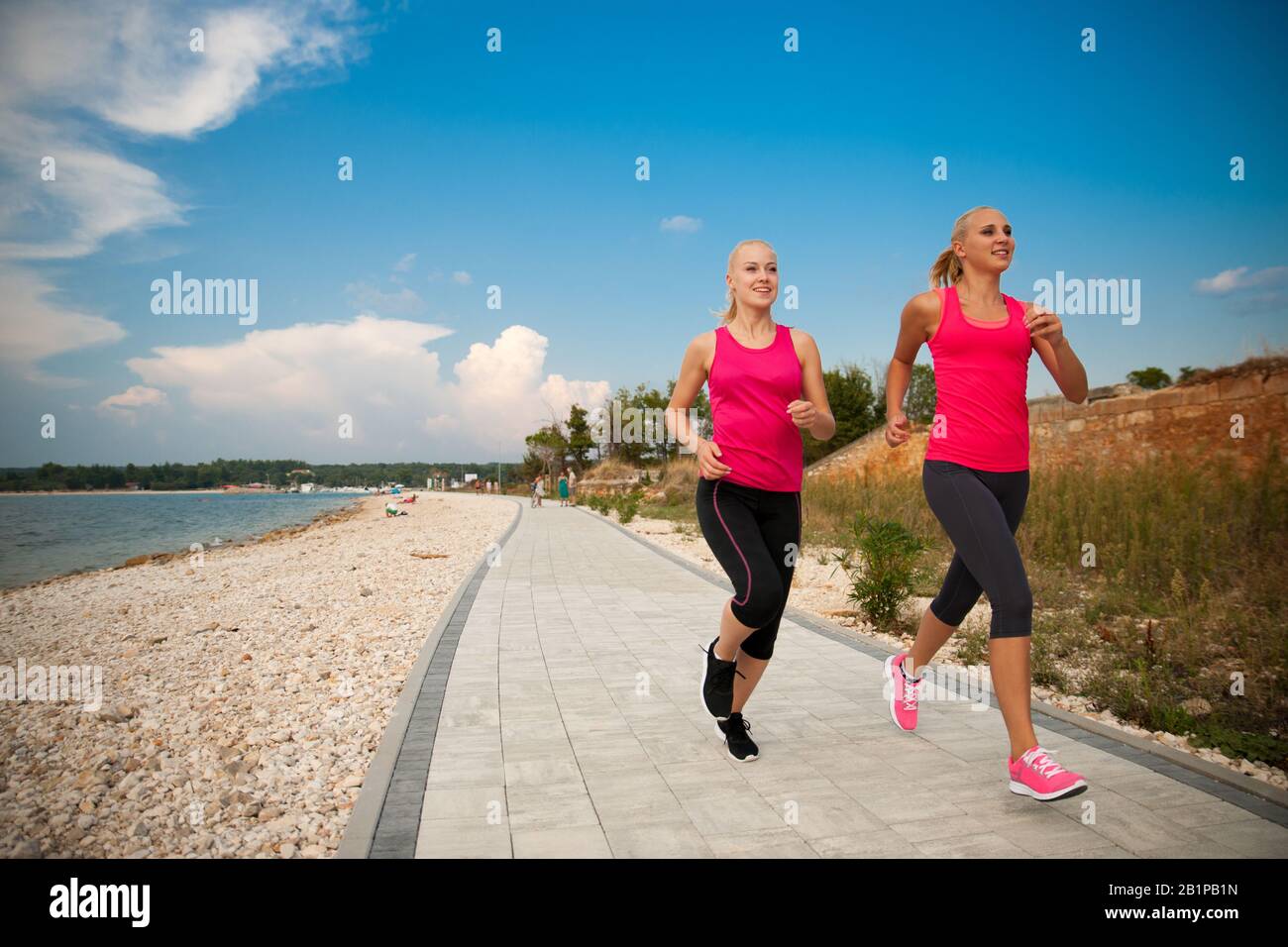Two women running on the beach hi-res stock photography and images - Alamy