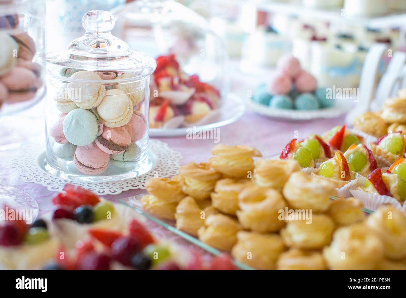 Wedding Reception Table setting. Colorful macarons and cakes Stock ...