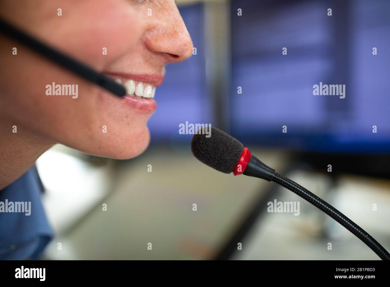 Call centre employee communicating over phone using an external ...