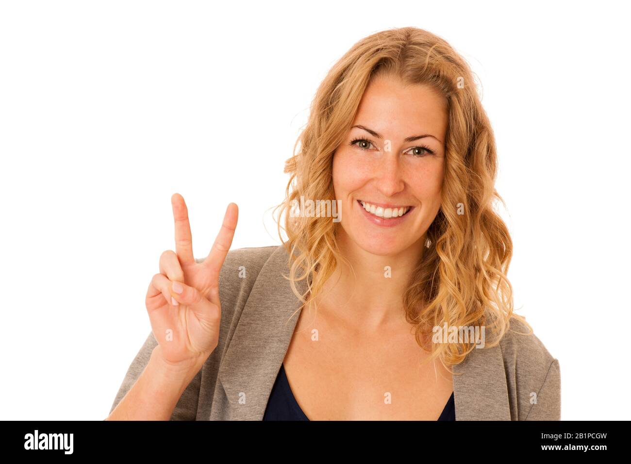Smiling young woman showing v sign hi-res stock photography and images ...