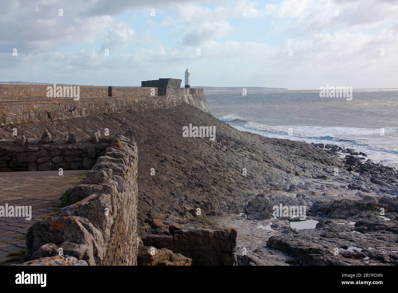 Looking along the concrete and stone built jetty towards the harbour ...