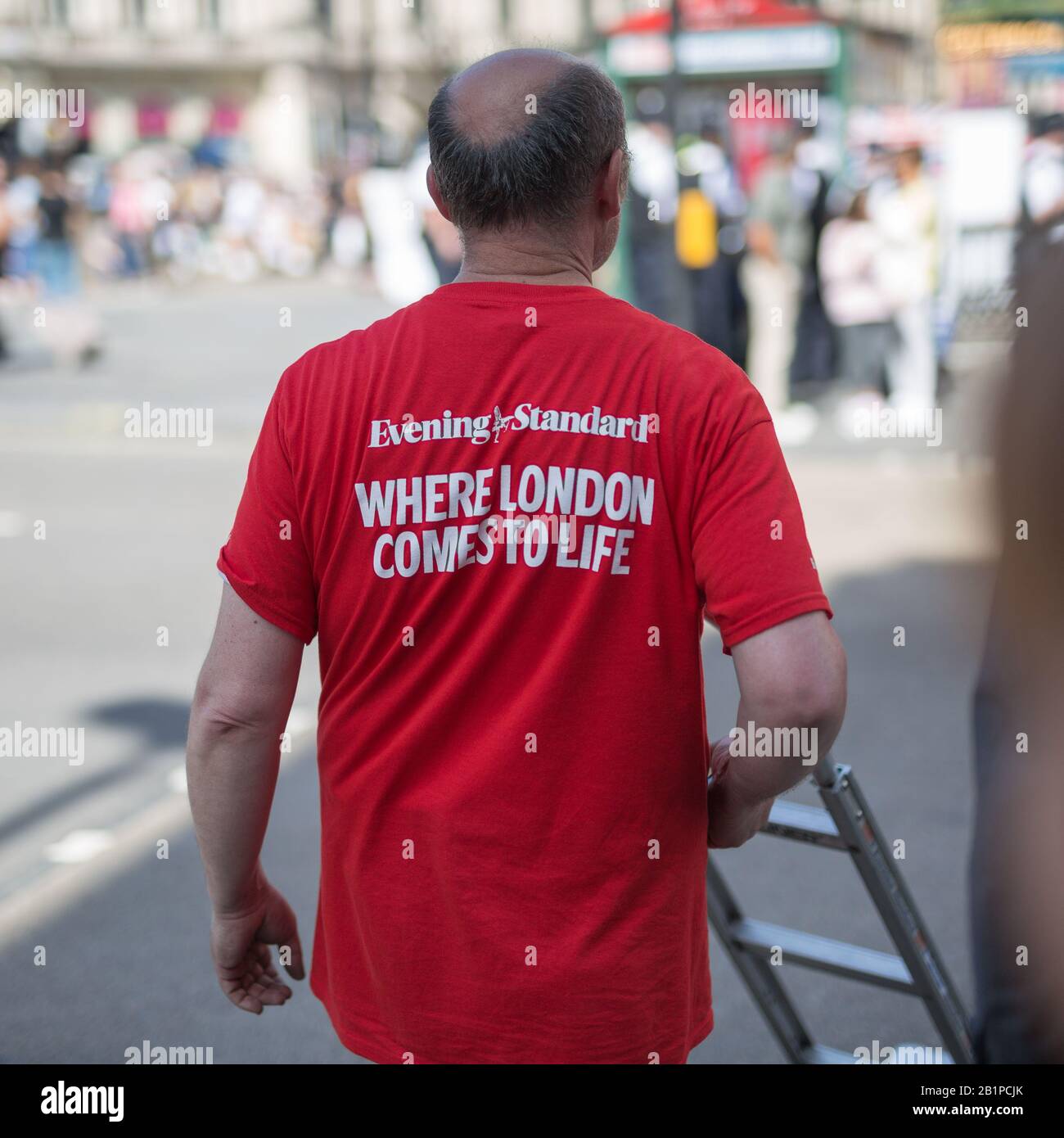 Slogan Written on the Red Shirt of a Man who Delivers Magazines in the ...