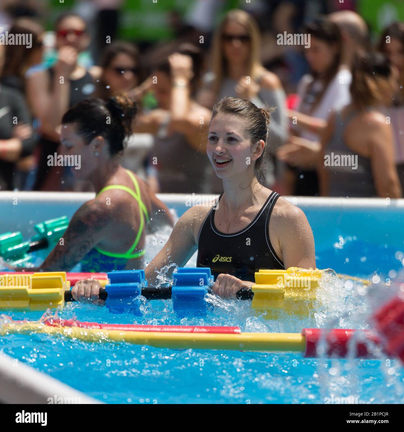Girls Doing Water Aerobics with Floating Pool Dumbbells Outdoor in a ...