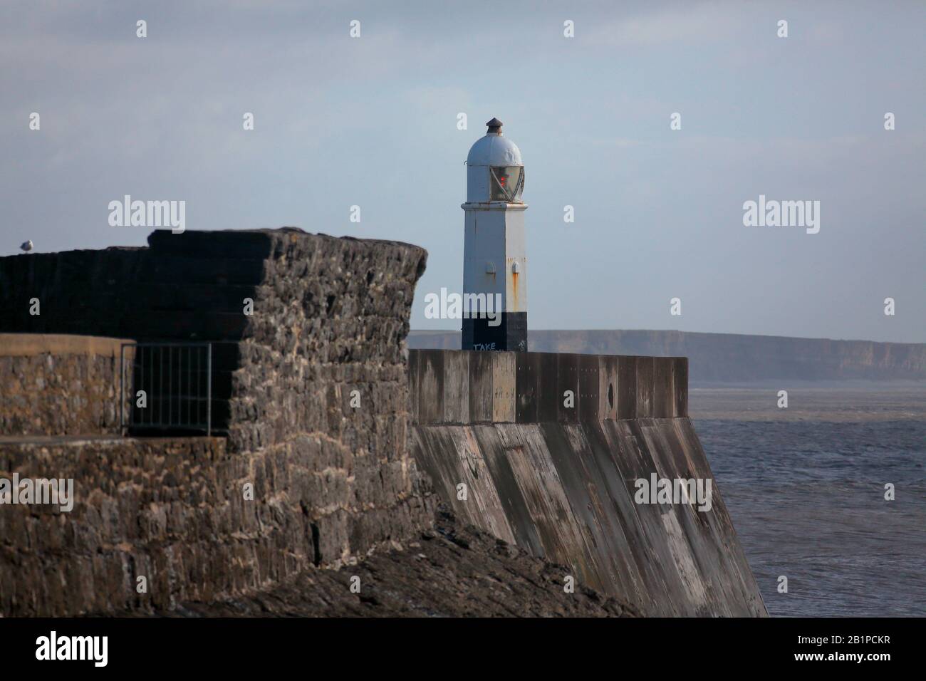 Looking along the concrete and stone built jetty towards the harbour ...
