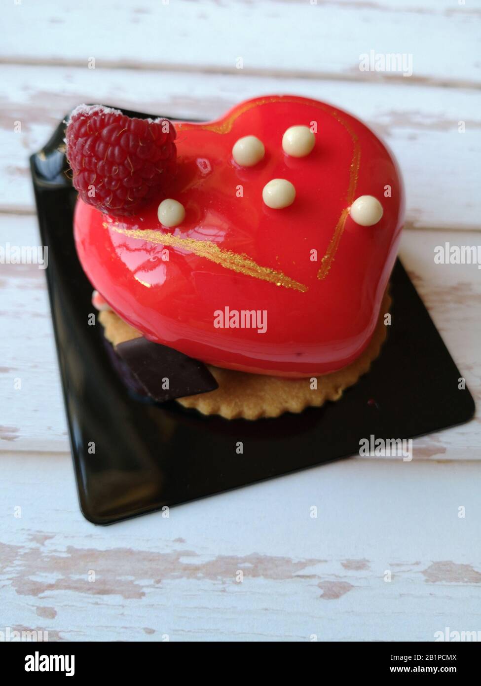 Red Heart-shaped Pastry with Biscuit and Raspberry Stock Photo - Alamy