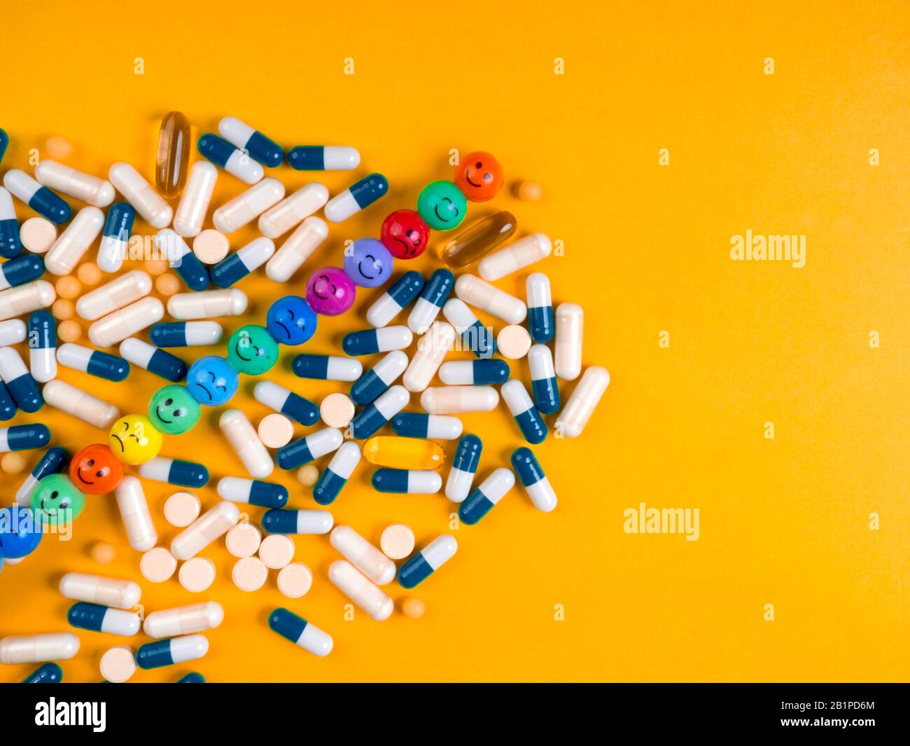 Multi color pills, tablets and capsules with colorful funny faces with ...
