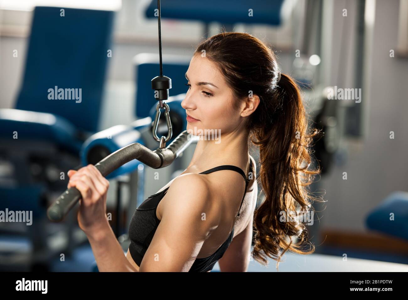 Beautiful fit woman works out in a fitness gym Stock Photo - Alamy