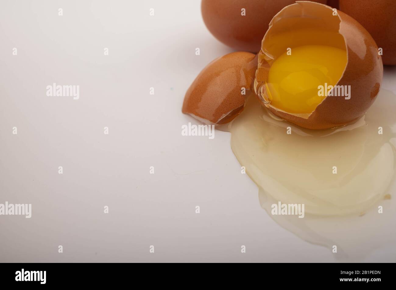 Broken chicken egg on a white background. Close up Stock Photo - Alamy