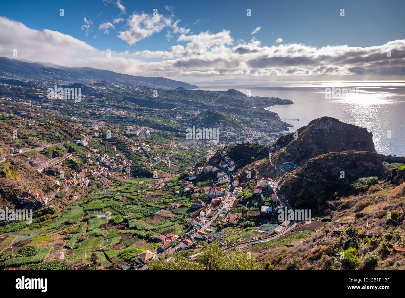 Agricultural landscape with green crops including sugar cane on steep ...